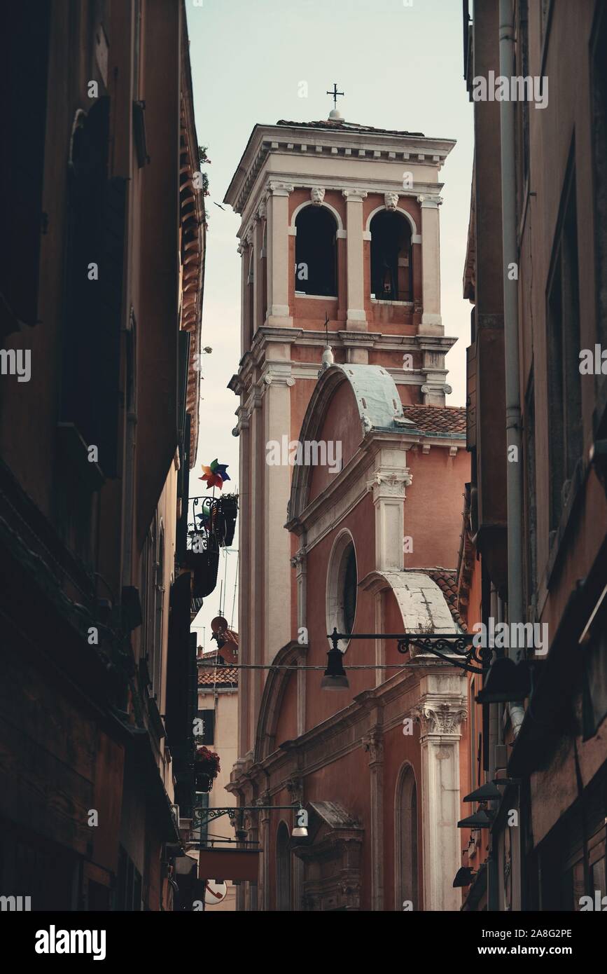 Alley view with bell tower and historical buildings in Venice, Italy ...