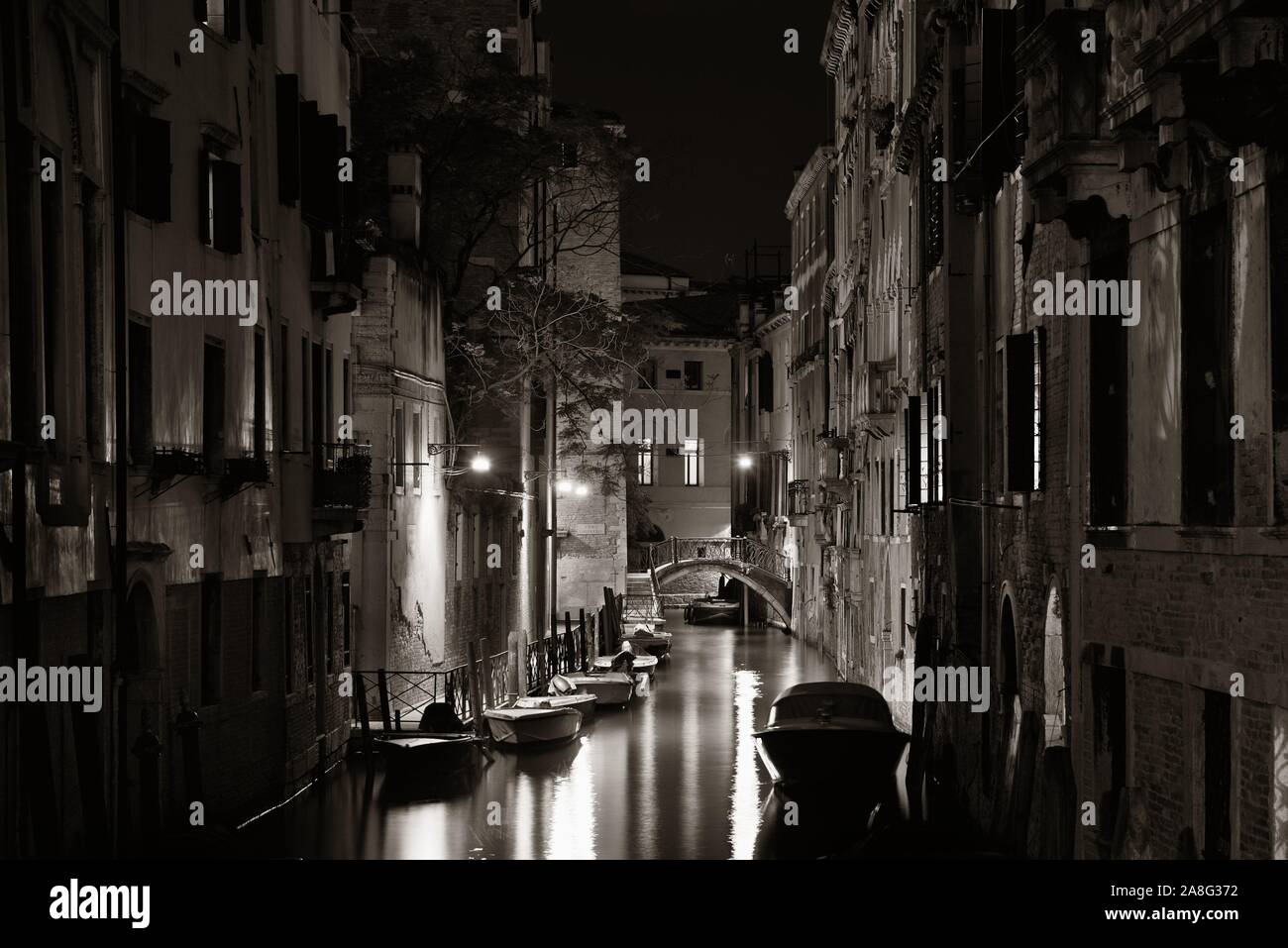 Venice canal view at night with bridge and historical buildings. Italy ...