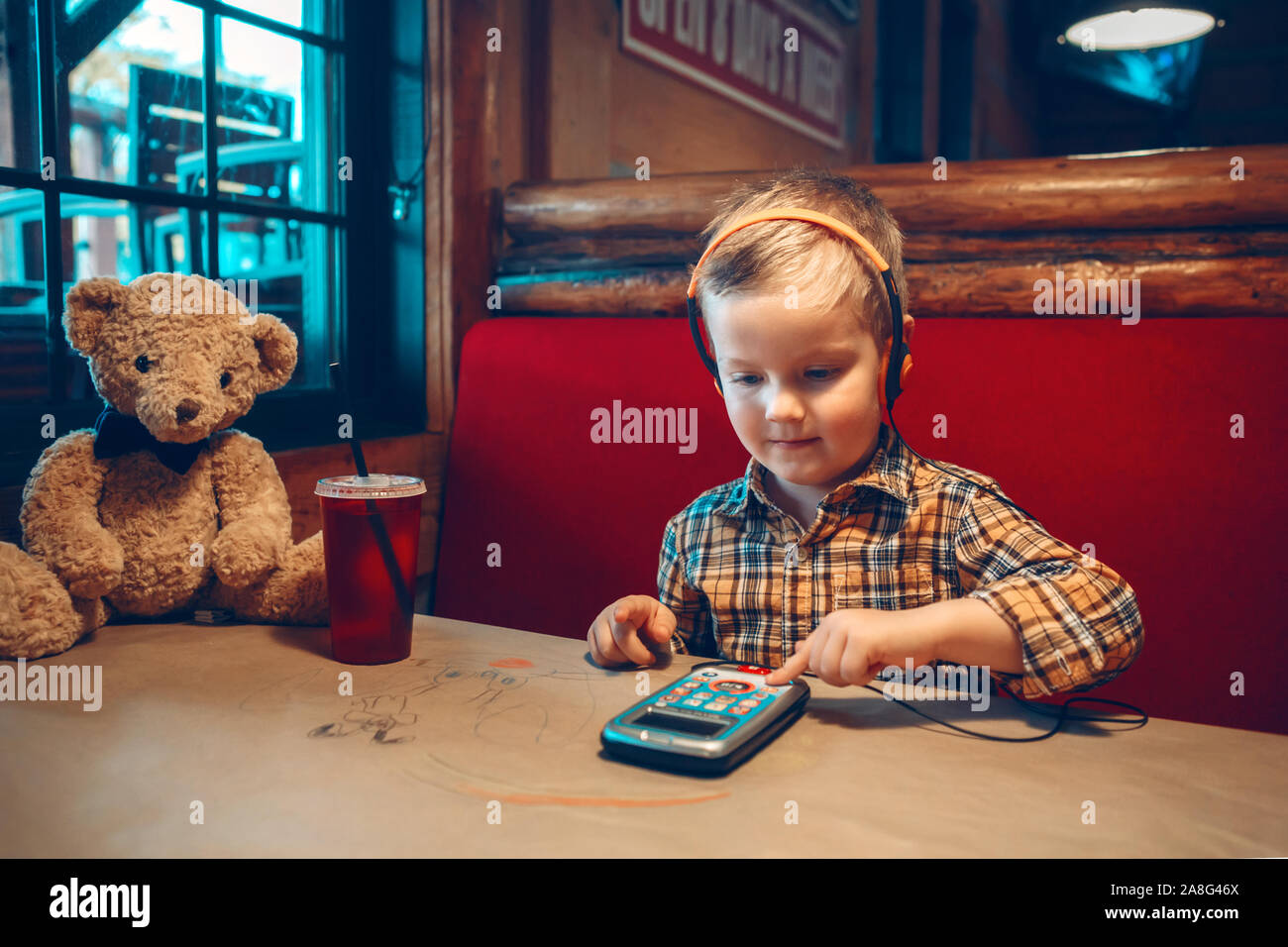Portrait of cute adorable funny little boy toddler playing digital toy ...