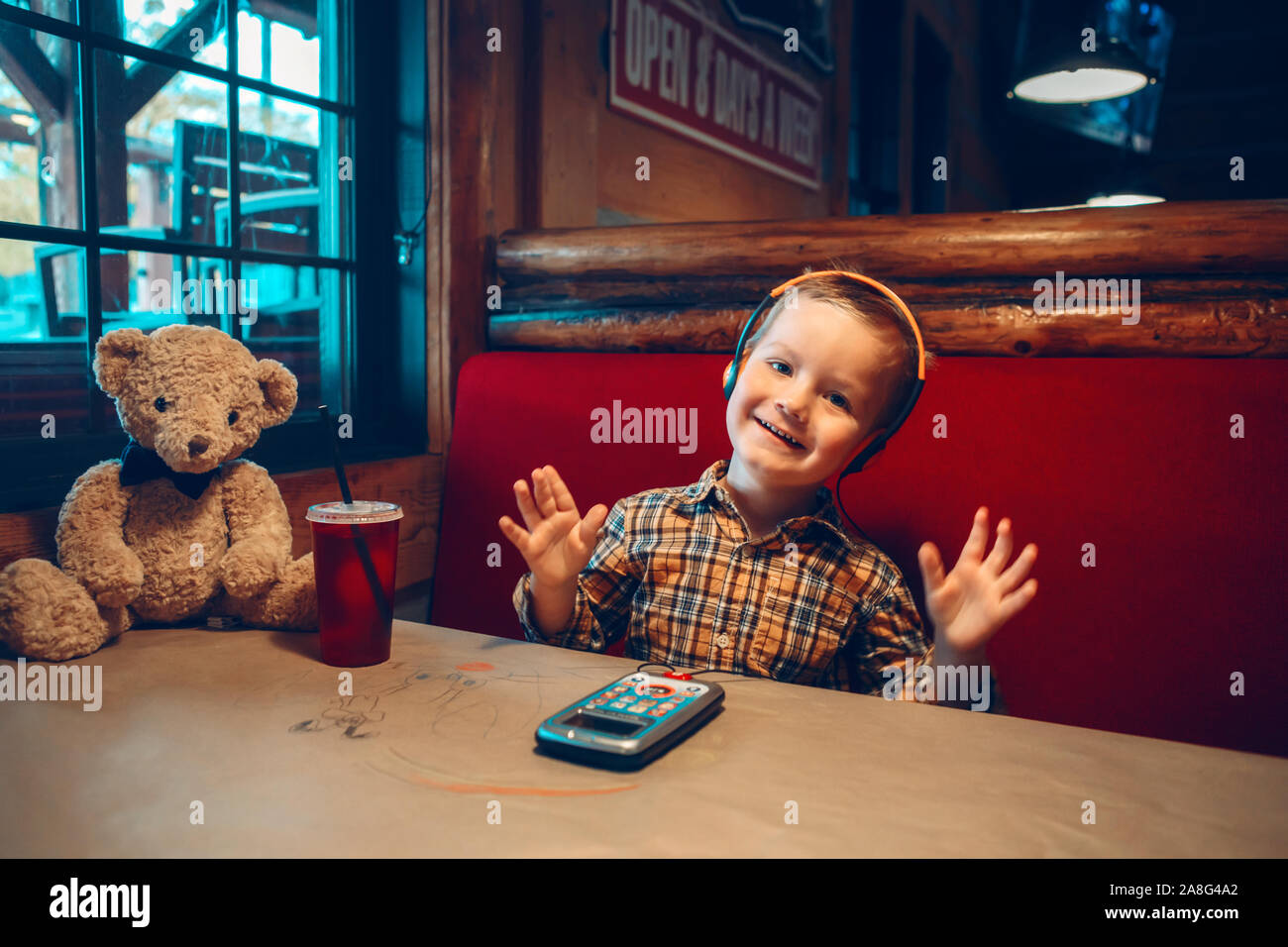 Portrait of cute adorable funny little boy toddler playing digital toy ...