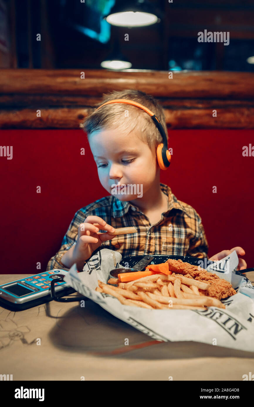 Portrait of cute adorable funny little boy toddler playing digital toy ...