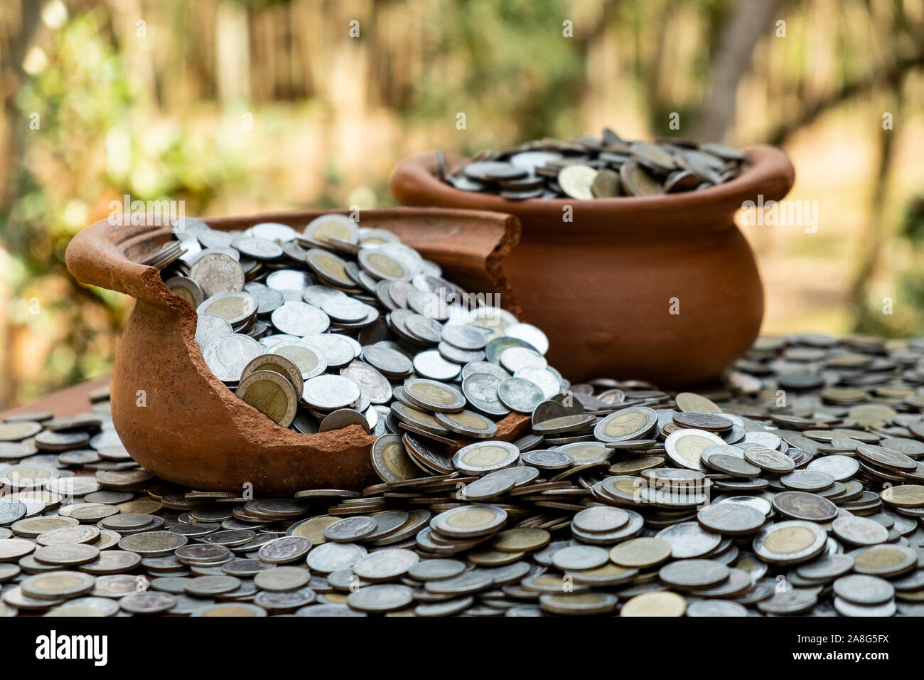 Stacking coin in broken treasure jar on black background, Money stack ...