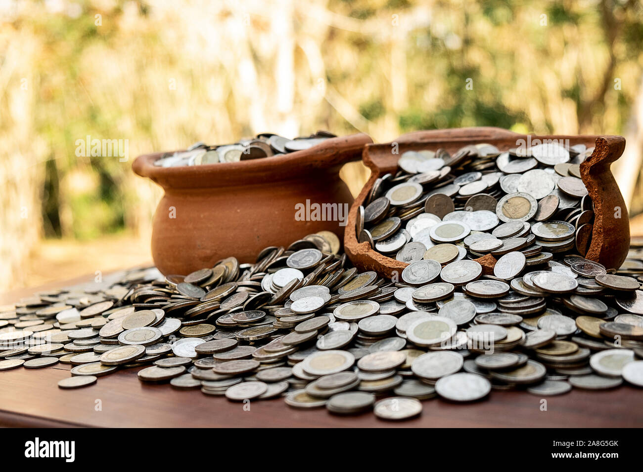 Stacking coin in broken treasure jar on black background, Money stack ...