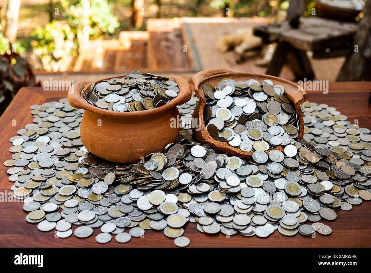 Stacking coin in broken treasure jar on black background, Money stack ...