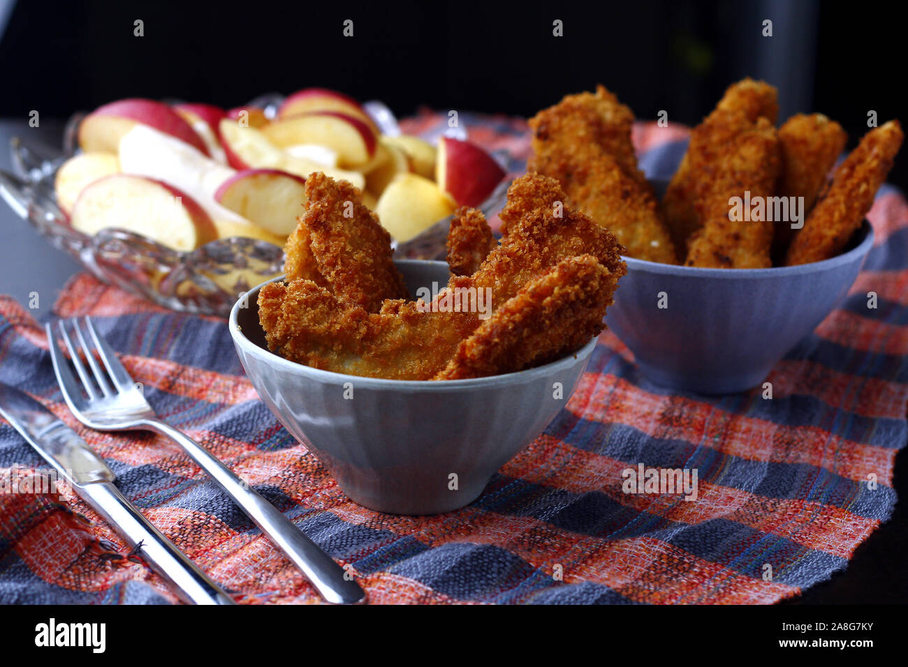 Photo of freshly cooked crispy chicken and fish strips and bowl of ...