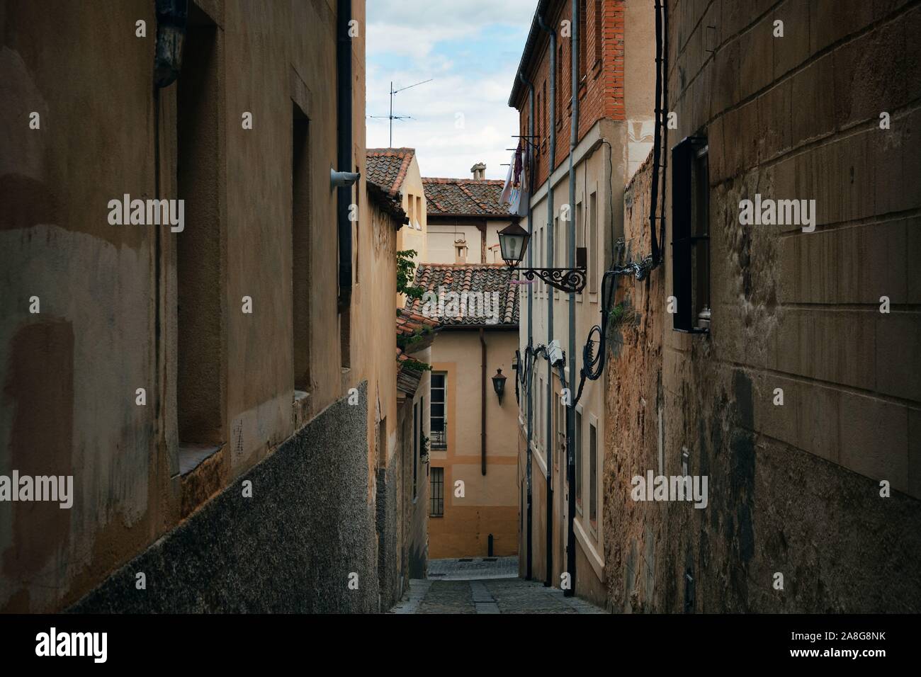 Segovia alley with old buildings street view in Spain Stock Photo - Alamy