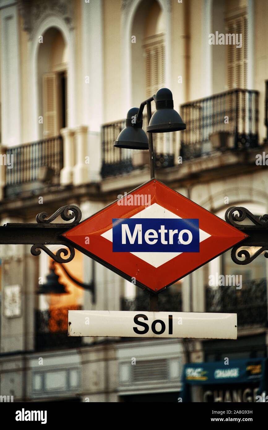 Metro sign of Sol station with business district buildings in street in ...