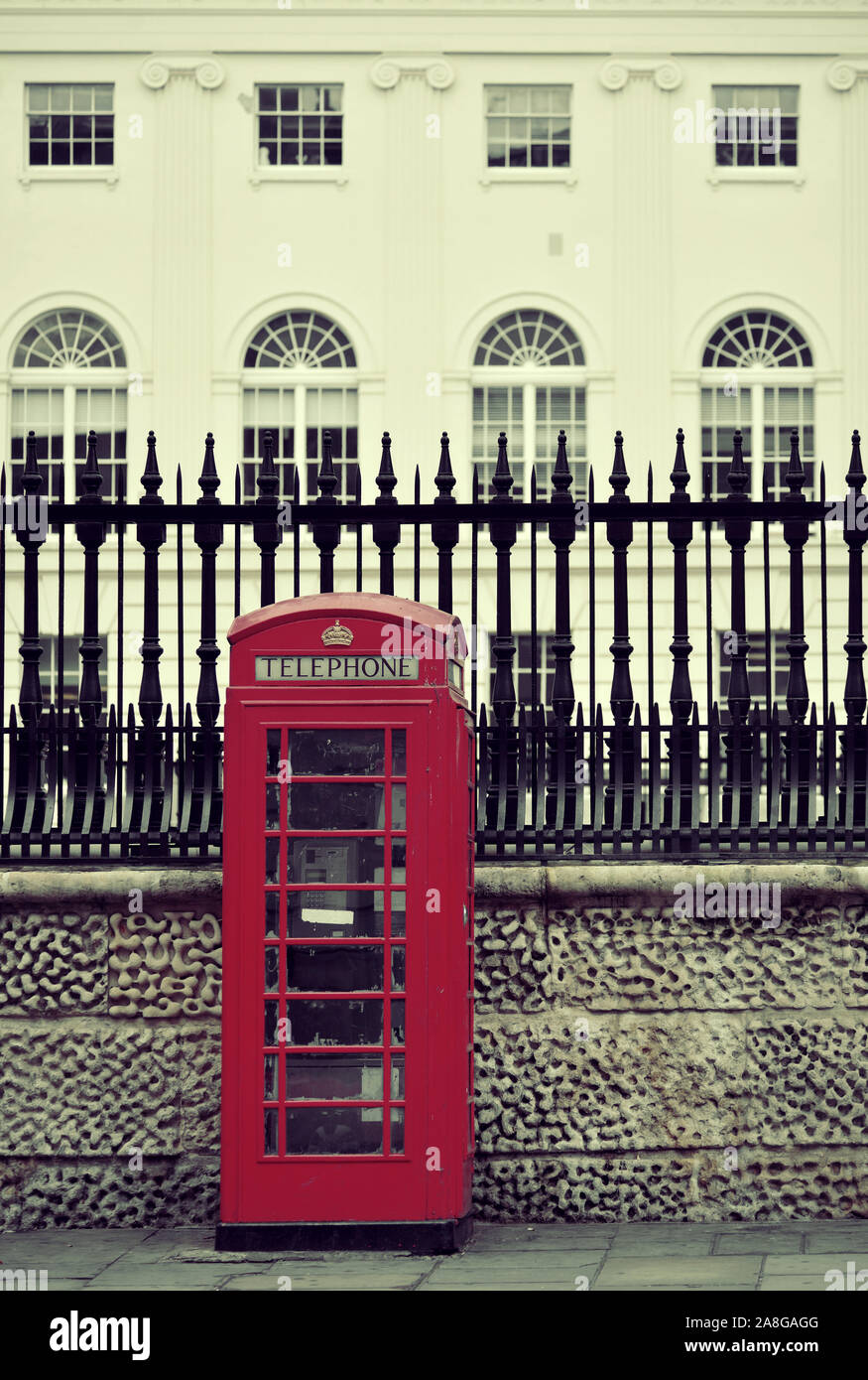 Red telephone box in street with historical architecture in London ...