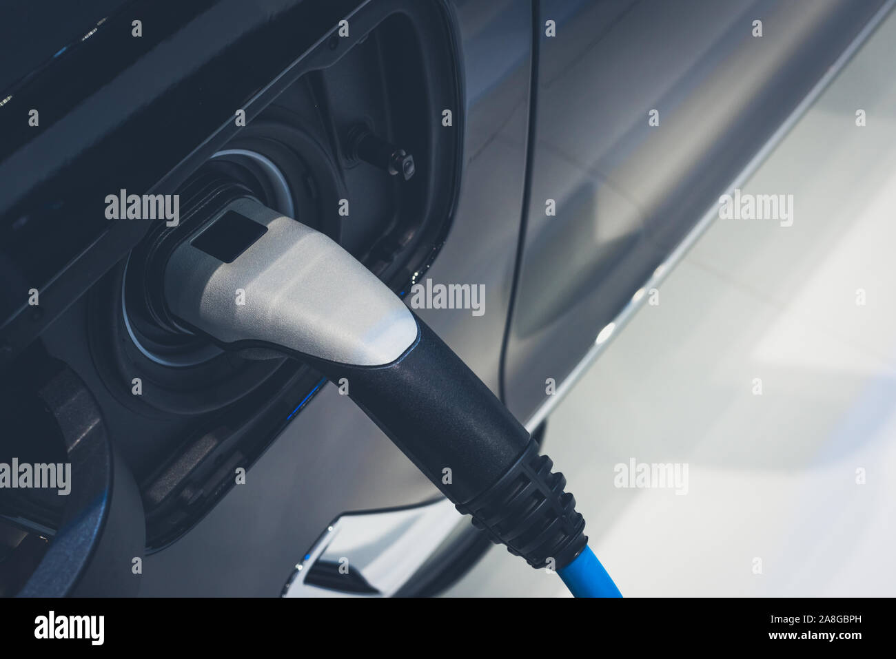 The process of charging an electric vehicle. Electric car socket for ...
