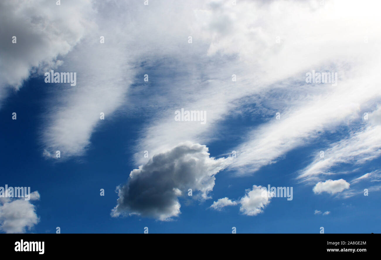 Fluffy white cumulus clouds with cumulostratus formations on a spring ...