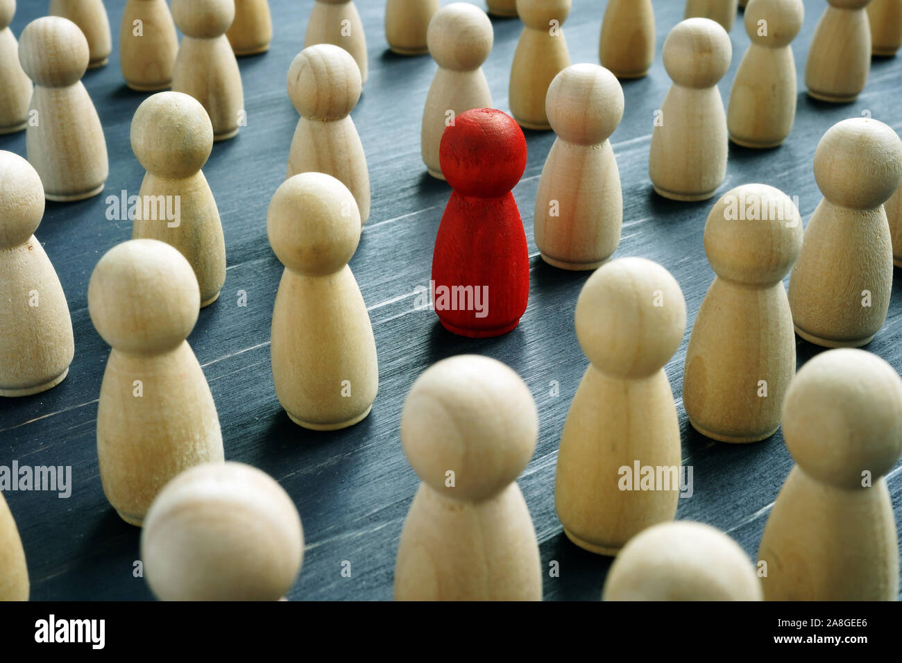 Unique concept. One different red figure in the crowd Stock Photo - Alamy