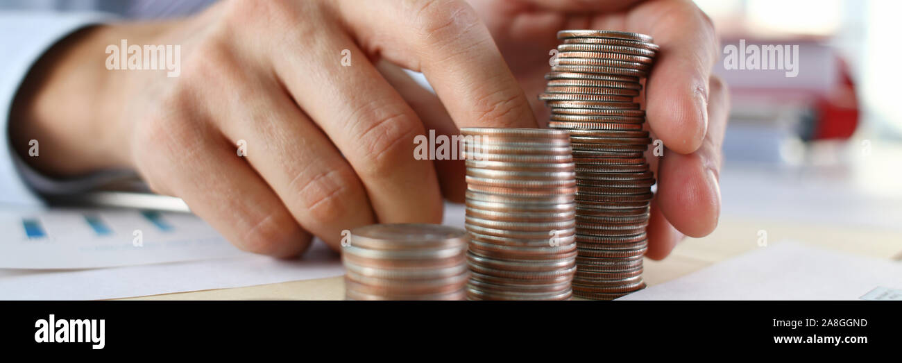 Hand businessman putting pin money Stock Photo - Alamy
