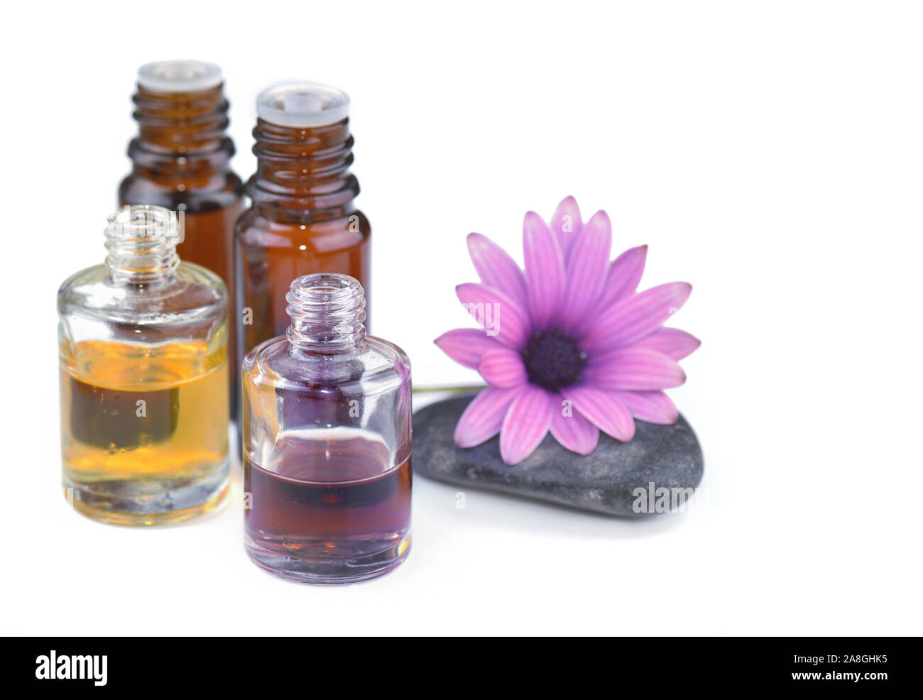 essential oil bottles and flower on white background Stock Photo - Alamy