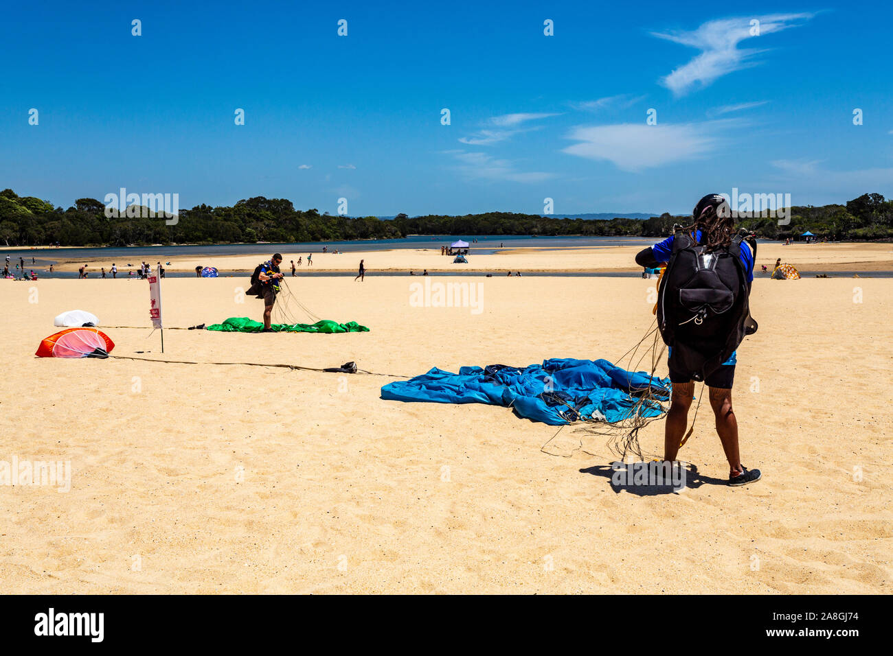 Skydivers and parachutes on the ground after a tandem skydive over ...