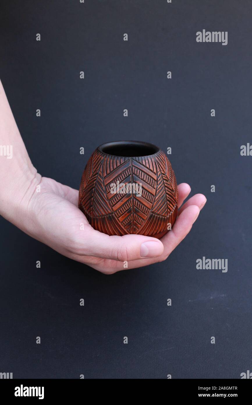 traditional red clay cup gourd for yerba mate tea on black back ...