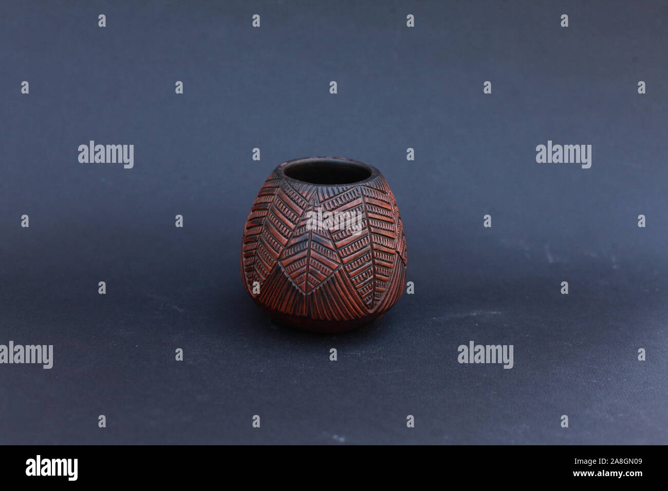 handmade red clay cup for yerba tea on black background, traditional ...