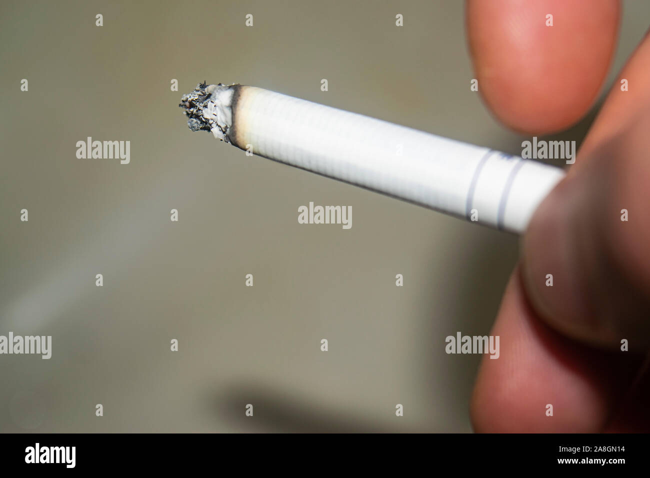 Cigarette in a man's hand concept photo. The dangers of Smoking ...