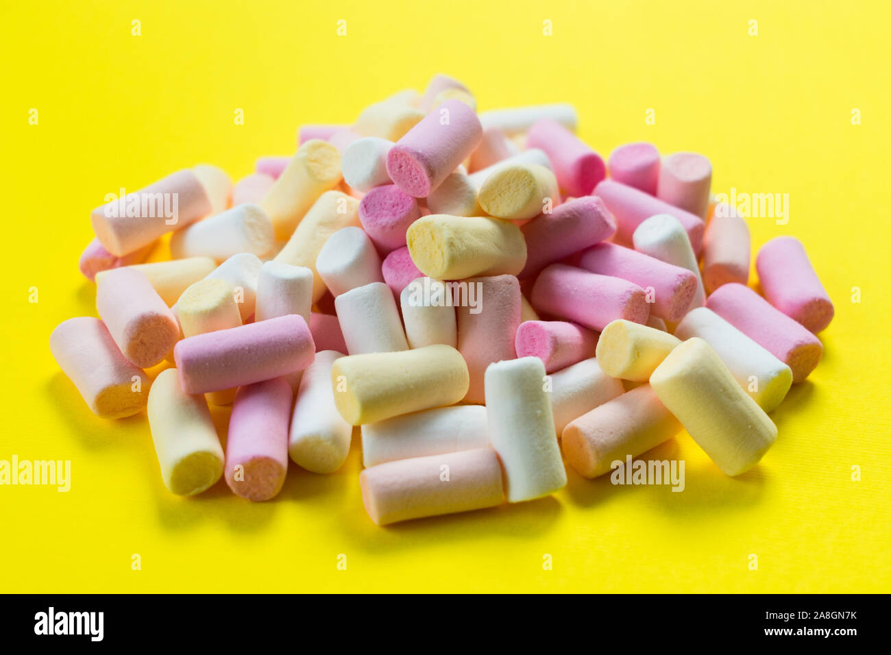 Multi-colored little marshmallows on a bright yellow background Stock ...