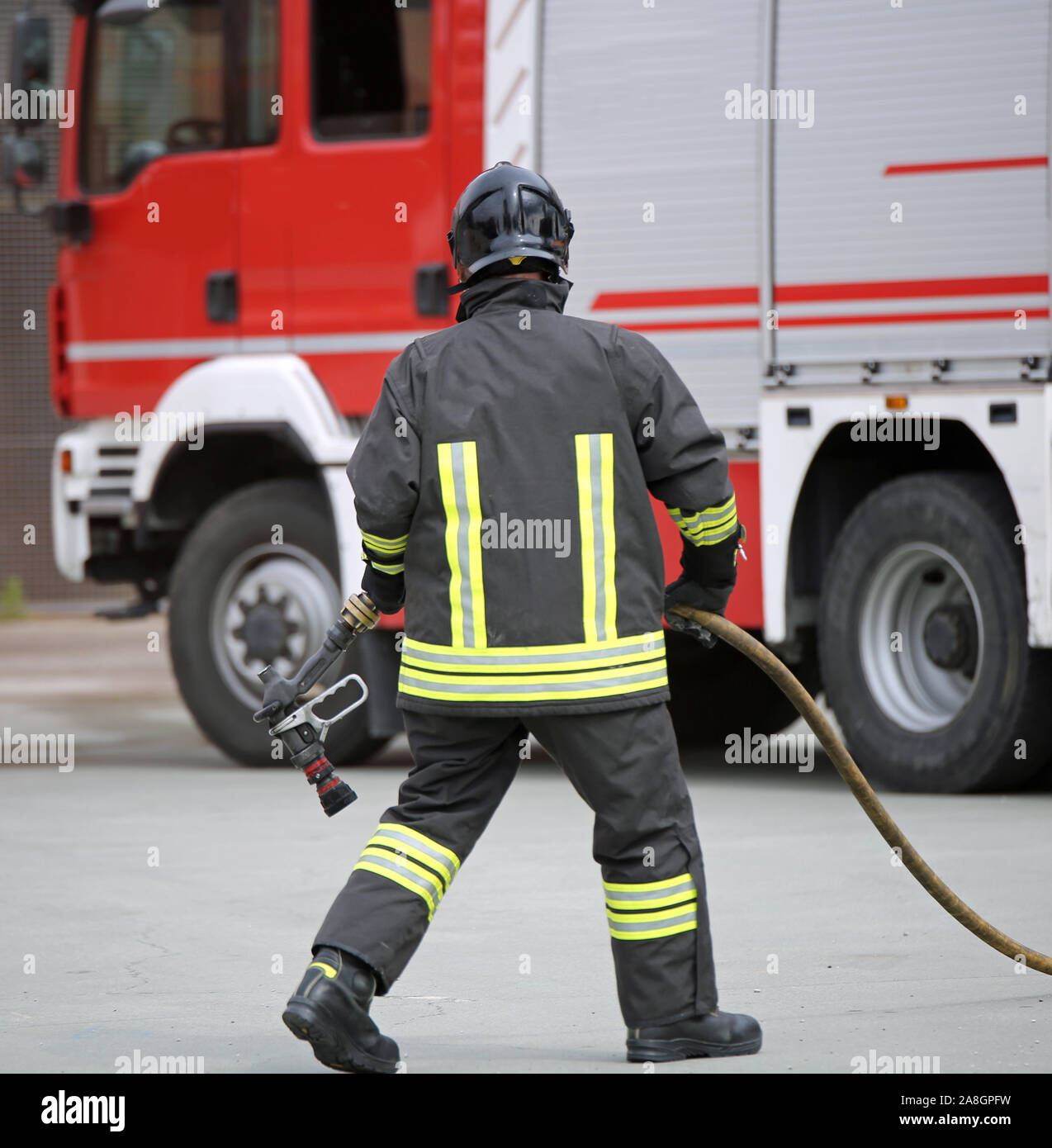 Fire engine and the fireman in uniform Stock Photo - Alamy