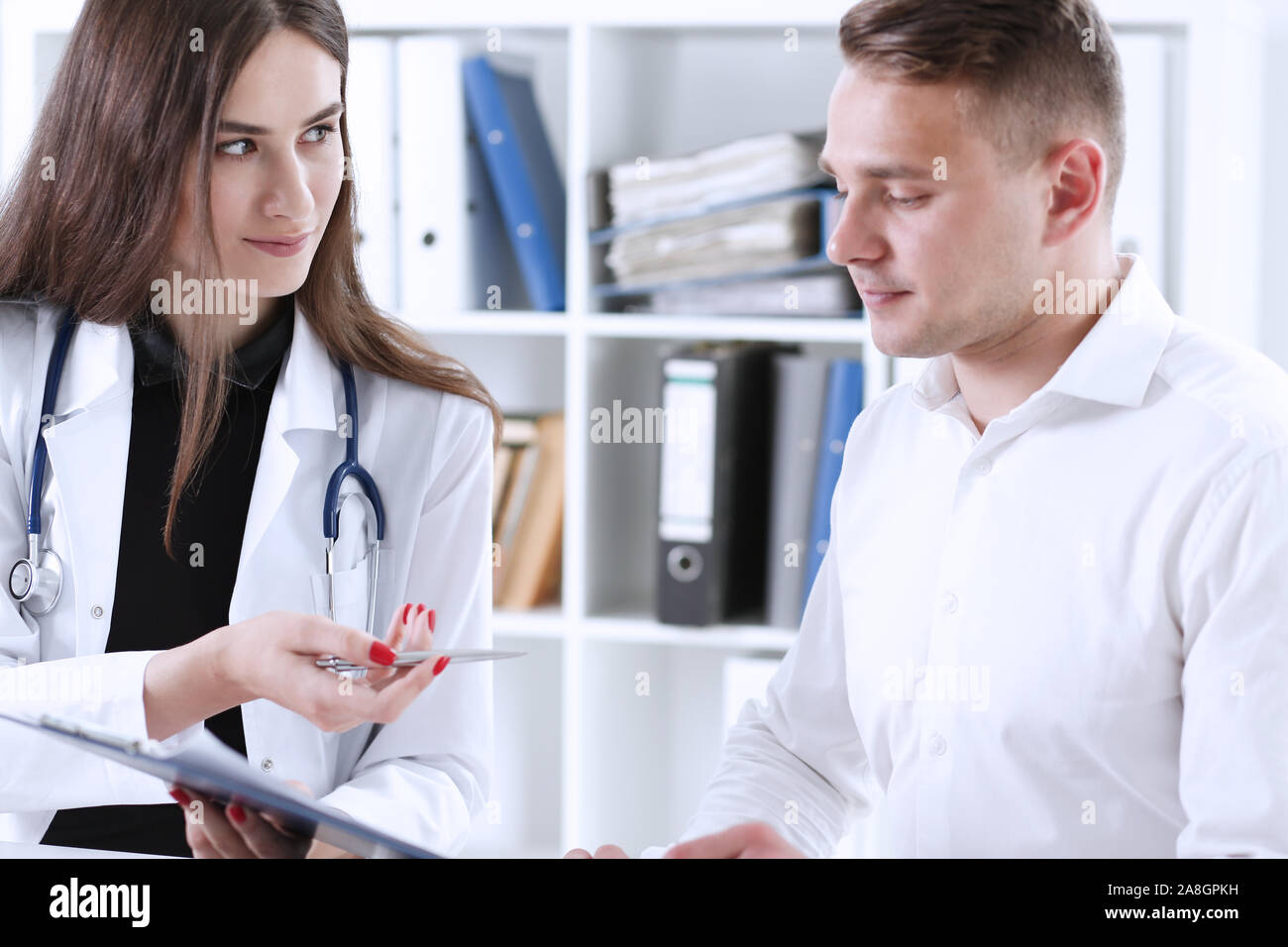 Smiling beautiful female medicine doctor explain diagnosis Stock Photo ...