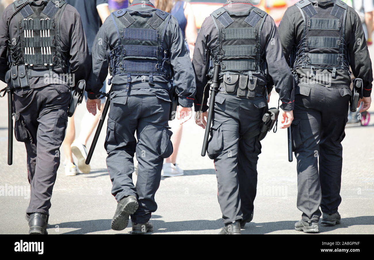 four cops patrolling the street of the metropolitan city Stock Photo ...