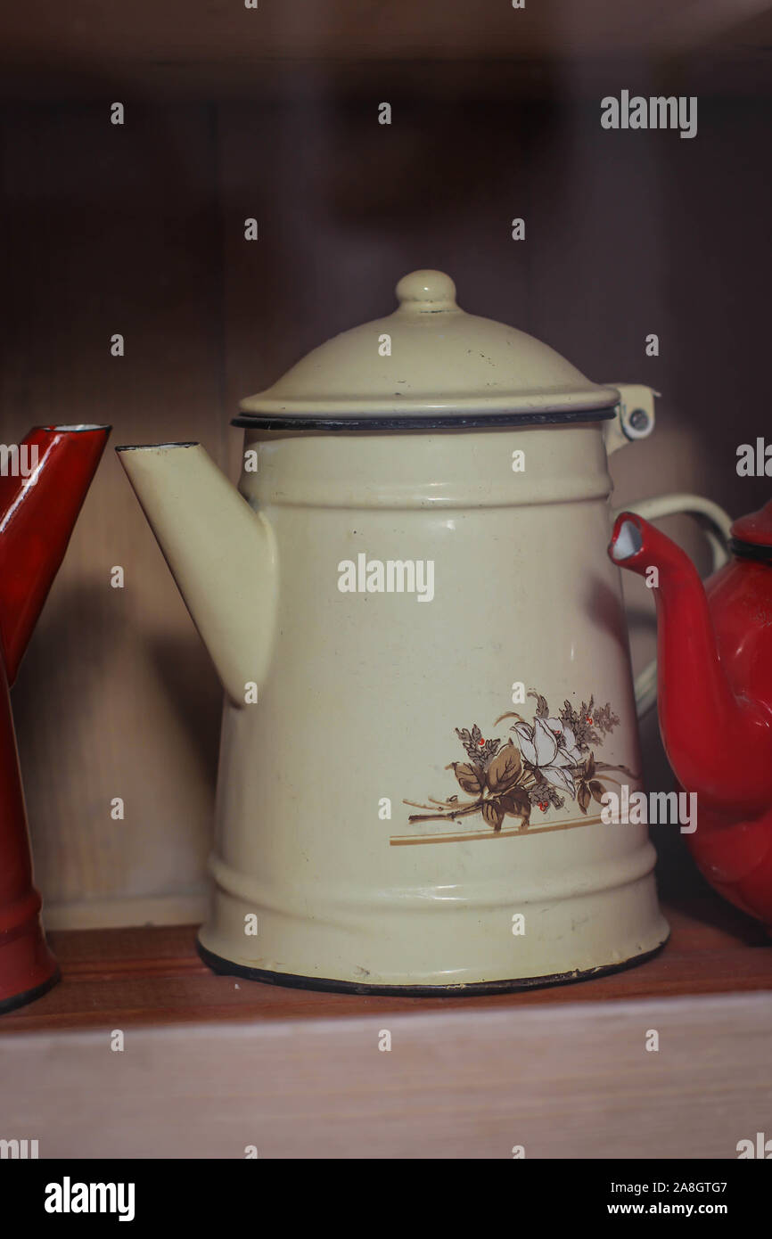 Single white elongated tin kettle with painted flowers Stock Photo - Alamy