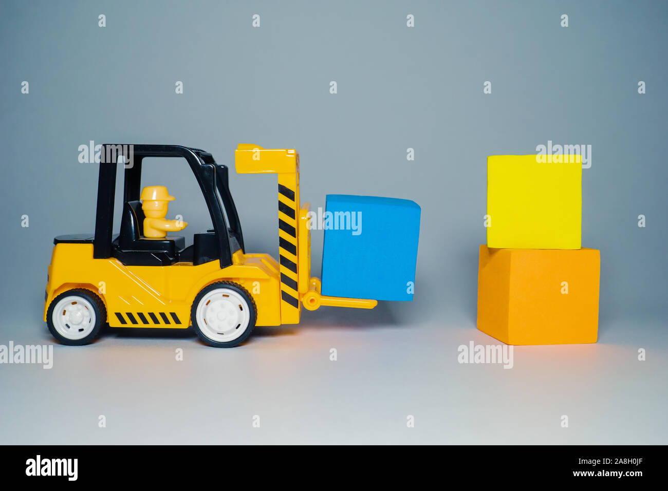 Yellow forklift toy load color cubes. Toys for children. Small forklift ...
