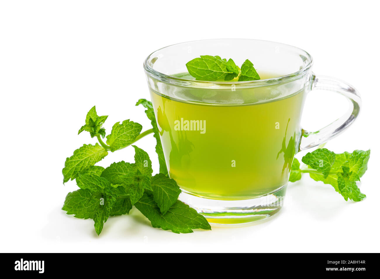 Green mint tea in clear glass cup isolated on white Stock Photo - Alamy