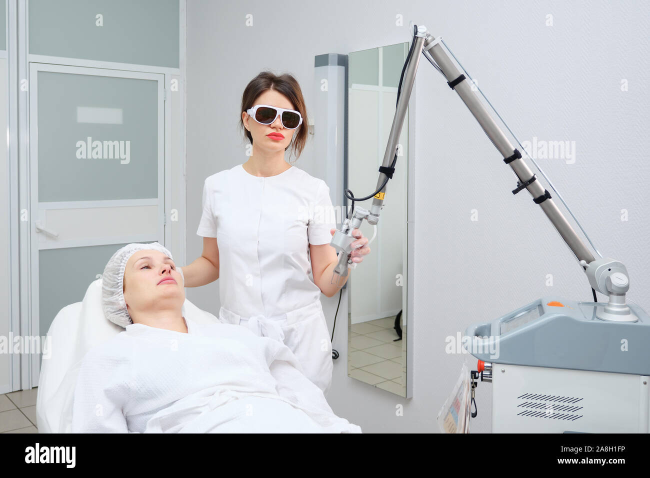 beauty salon girl worker carries out hair removal using latest ...