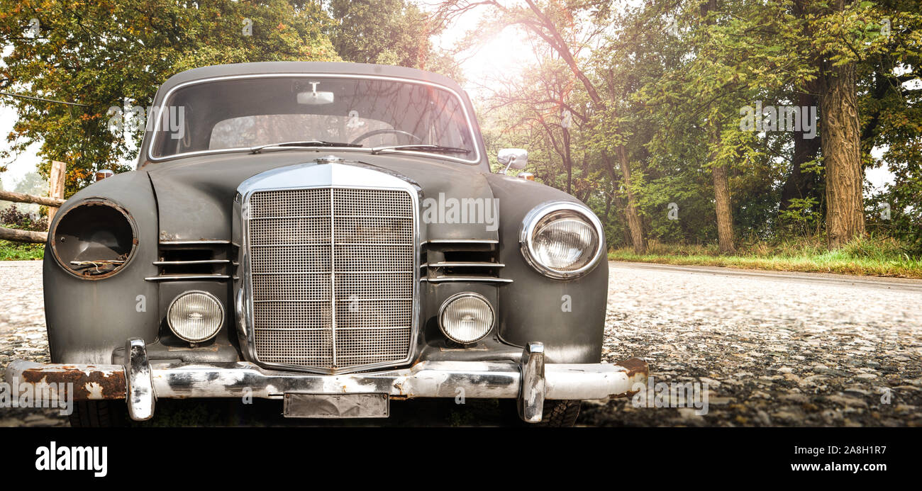 Broken old car in a country road Stock Photo - Alamy