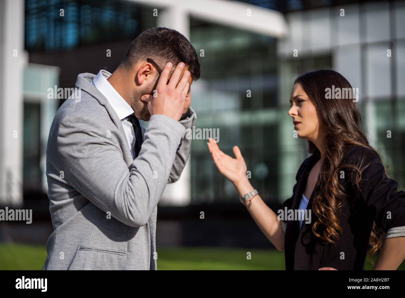 Overworked businessman is talking to colleague after work Stock Photo ...