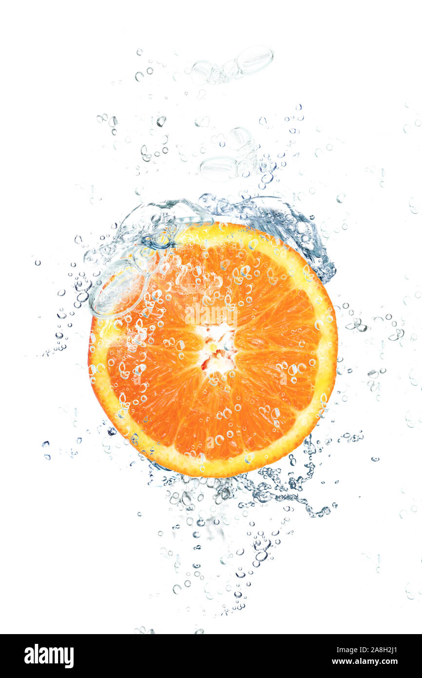 fresh orange falling in water Stock Photo - Alamy