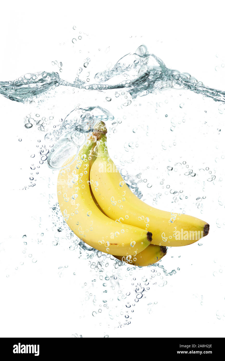 fresh bananas falling in water Stock Photo - Alamy