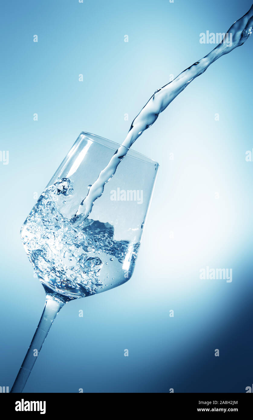 a glass with ice and liquid splash Stock Photo - Alamy