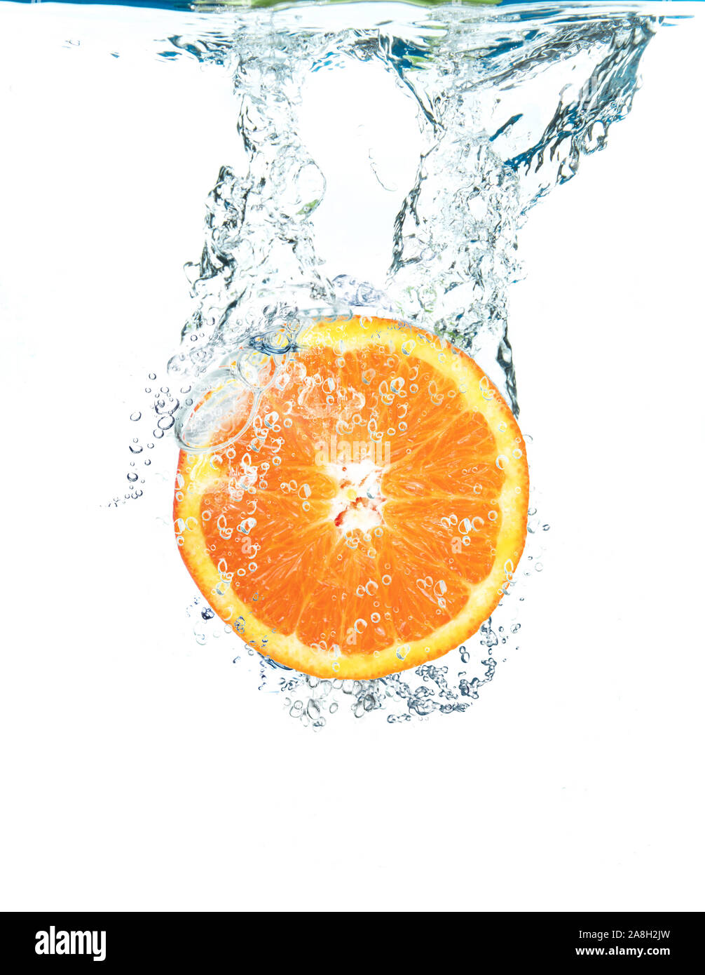 fresh orange falling in water Stock Photo - Alamy