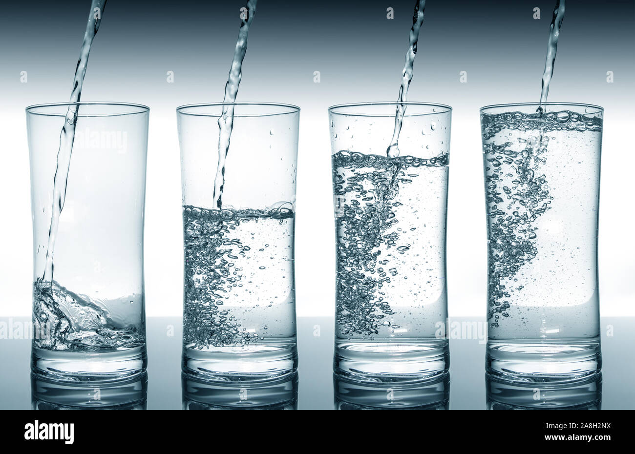 Water filling four glasses in sequence Stock Photo - Alamy