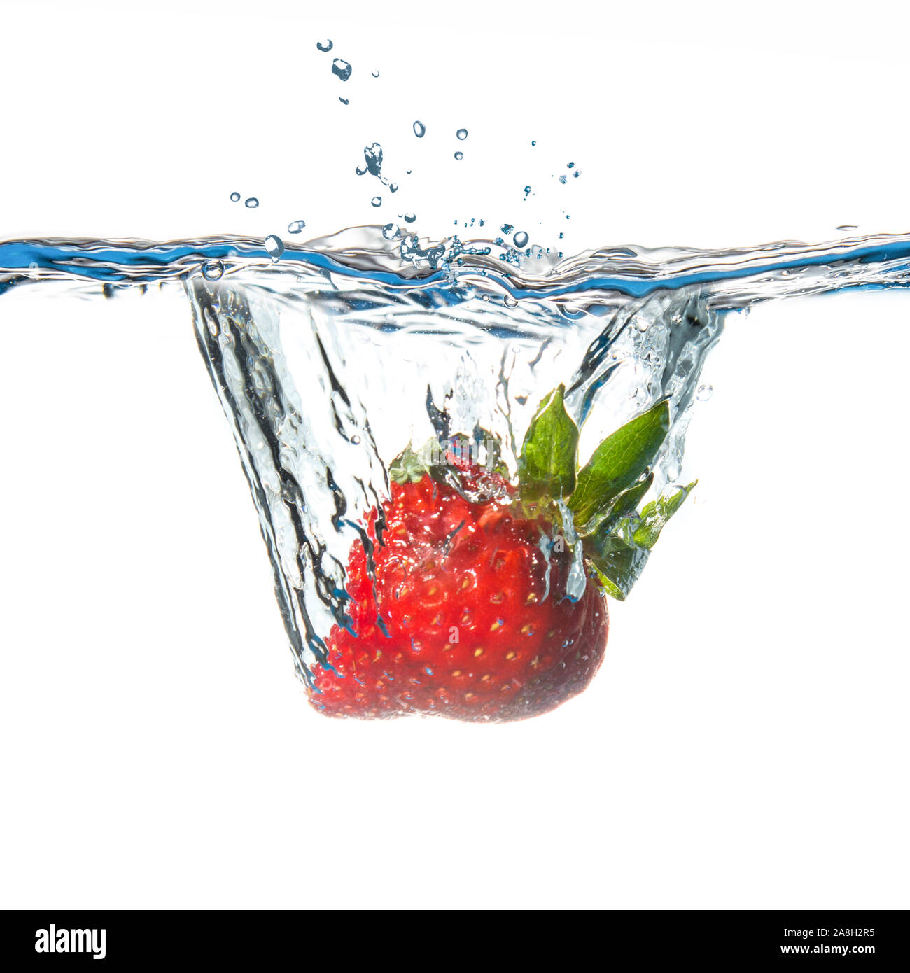 fresh strawberry falling in water Stock Photo - Alamy