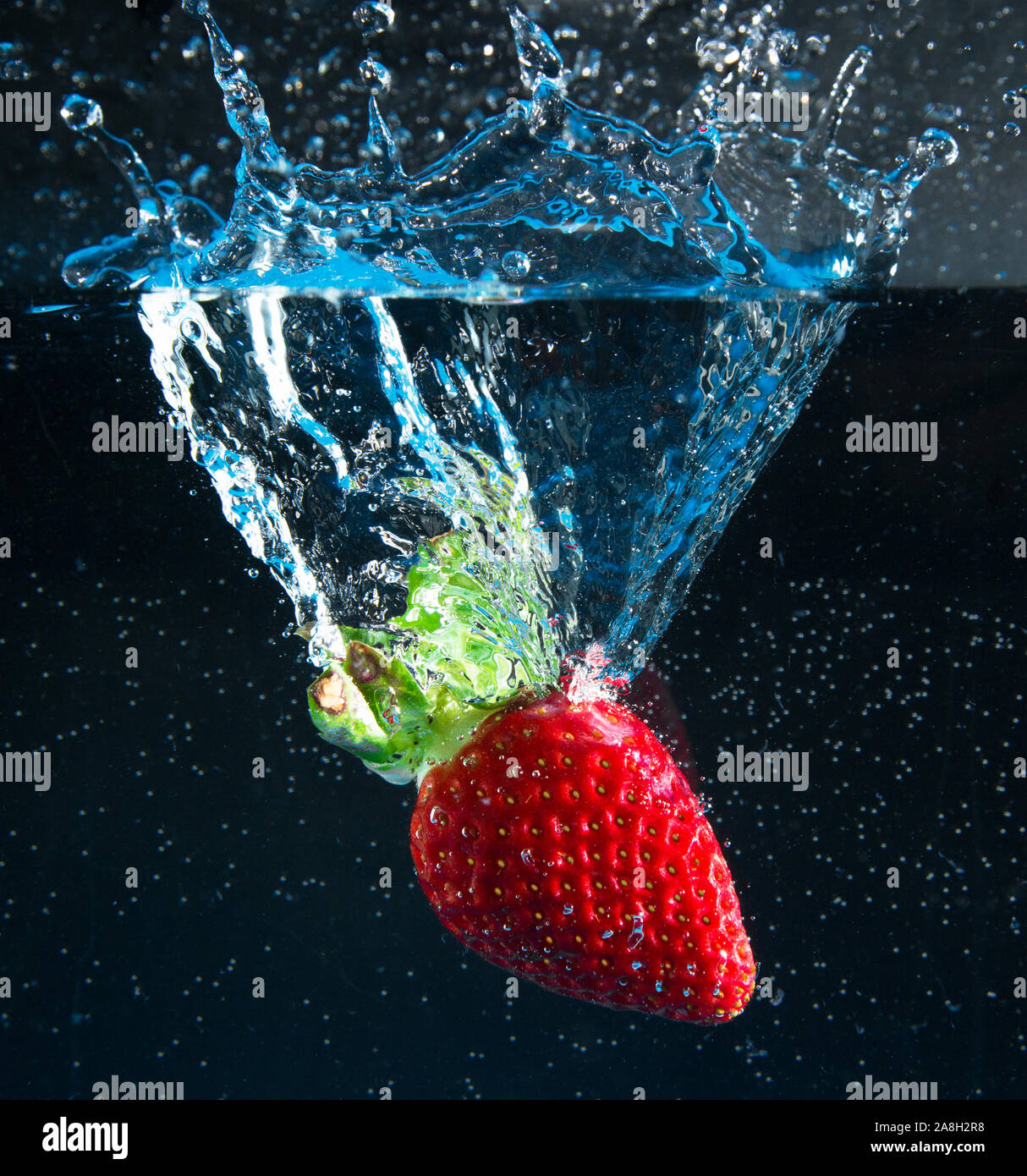 fresh strawberry falling in water Stock Photo - Alamy