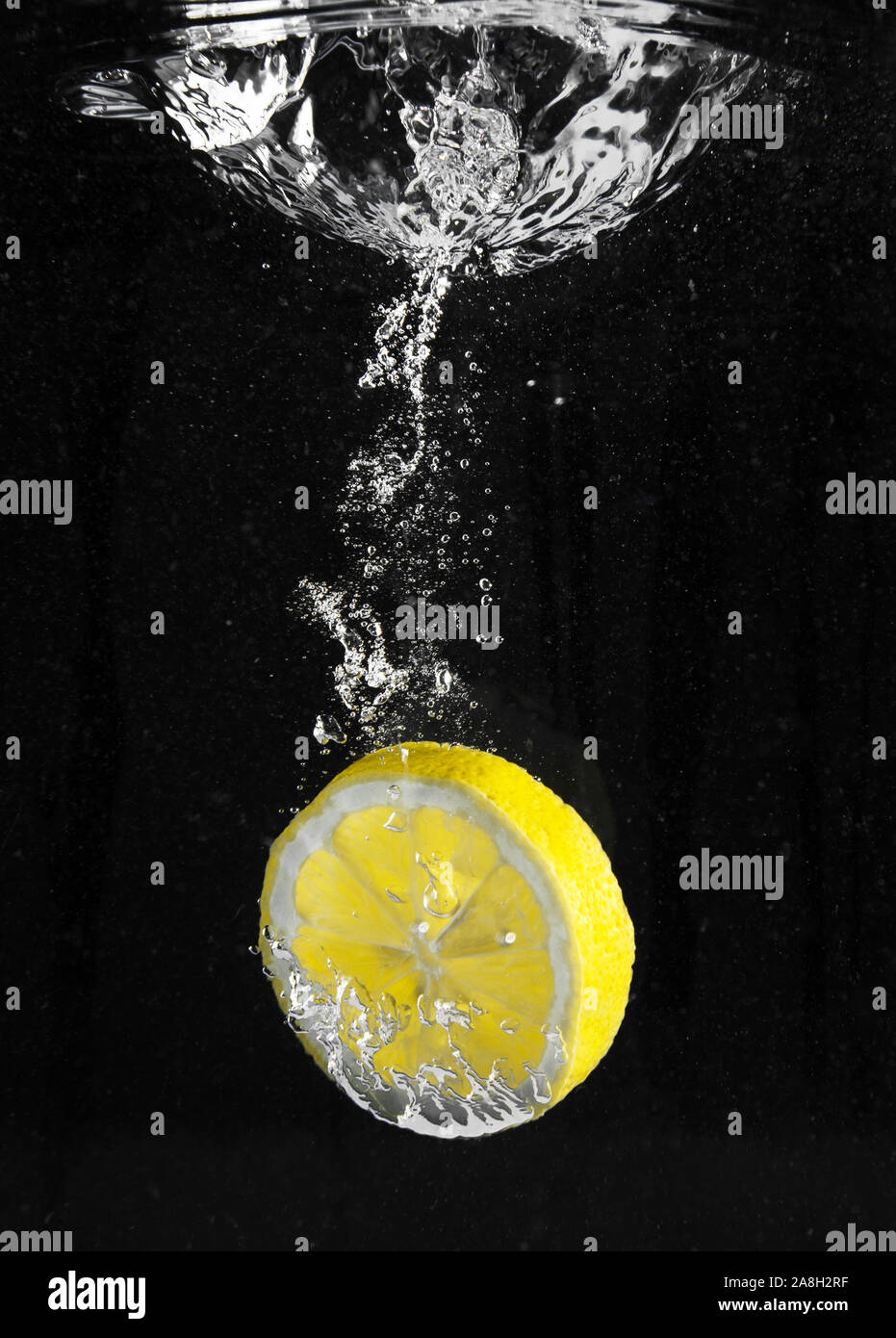 fresh lemon falling in water Stock Photo - Alamy