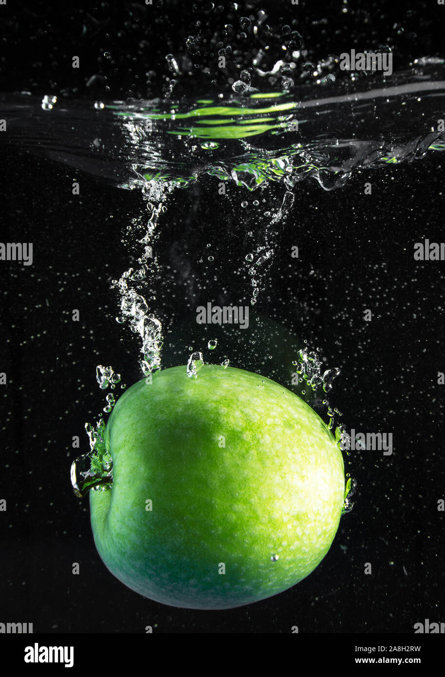 fresh apple falling in water Stock Photo - Alamy