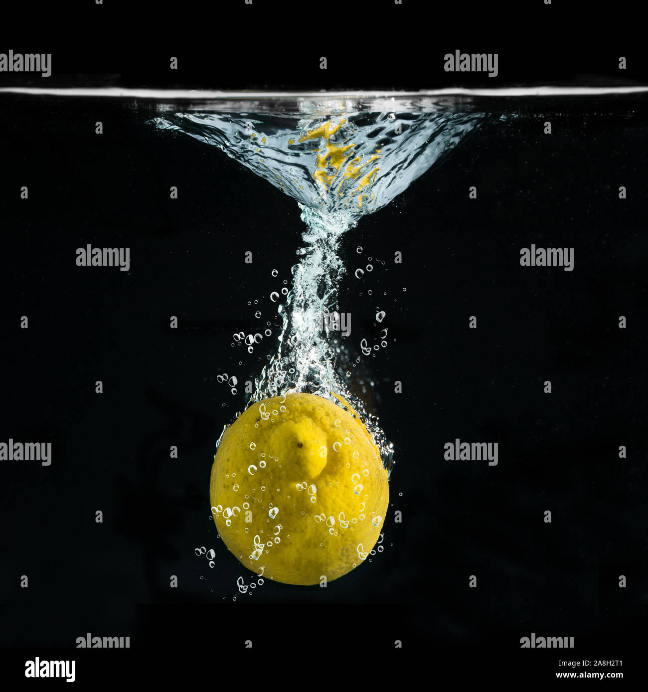 fresh lemon falling in water Stock Photo - Alamy