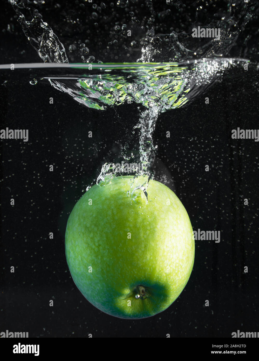 fresh apple falling in water Stock Photo - Alamy