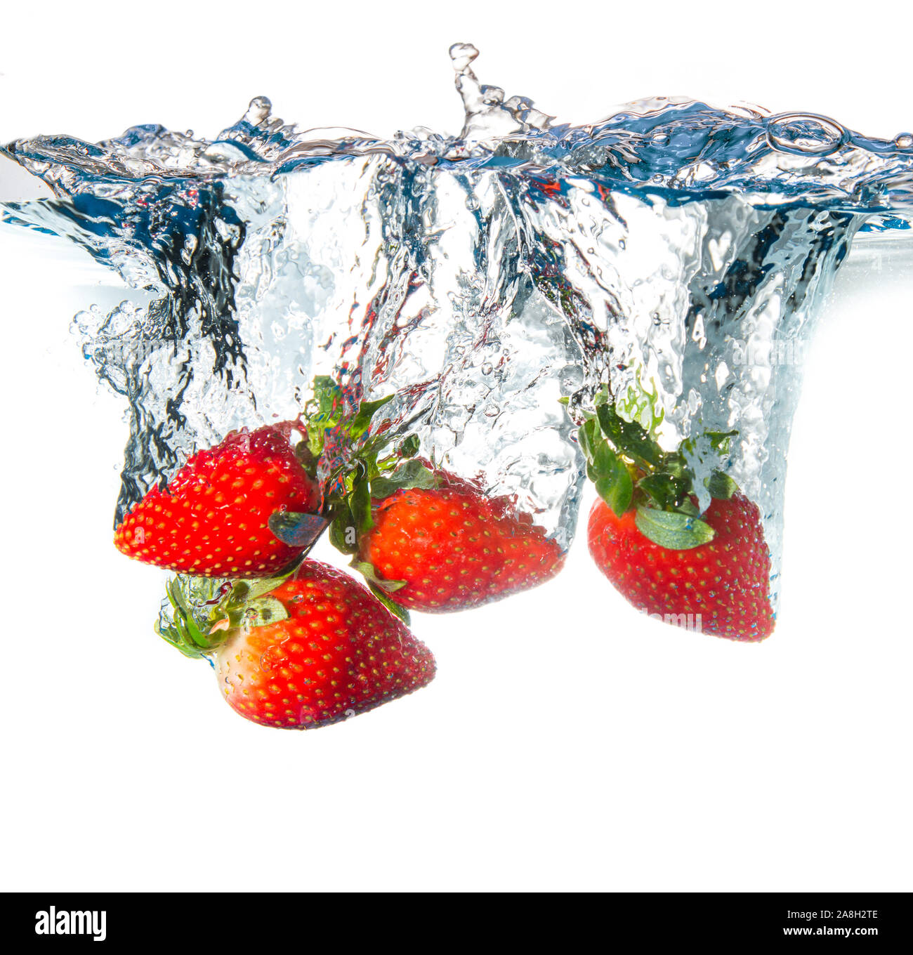 fresh strawberry falling in water Stock Photo - Alamy
