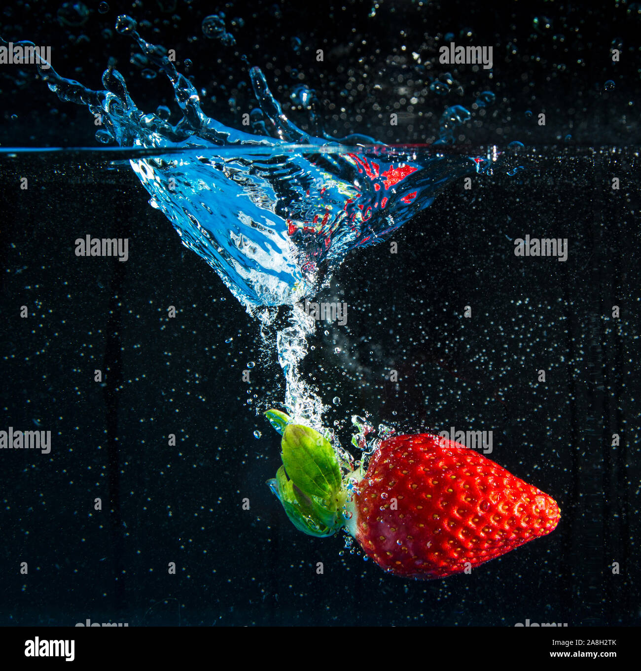 fresh strawberry falling in water Stock Photo - Alamy