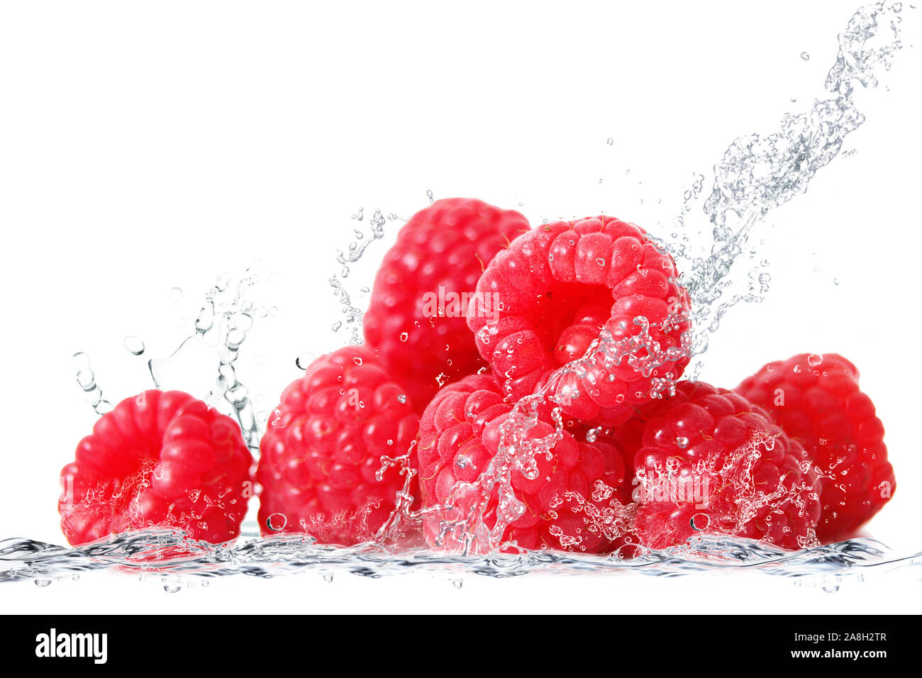 fresh raspberries falling in water Stock Photo - Alamy