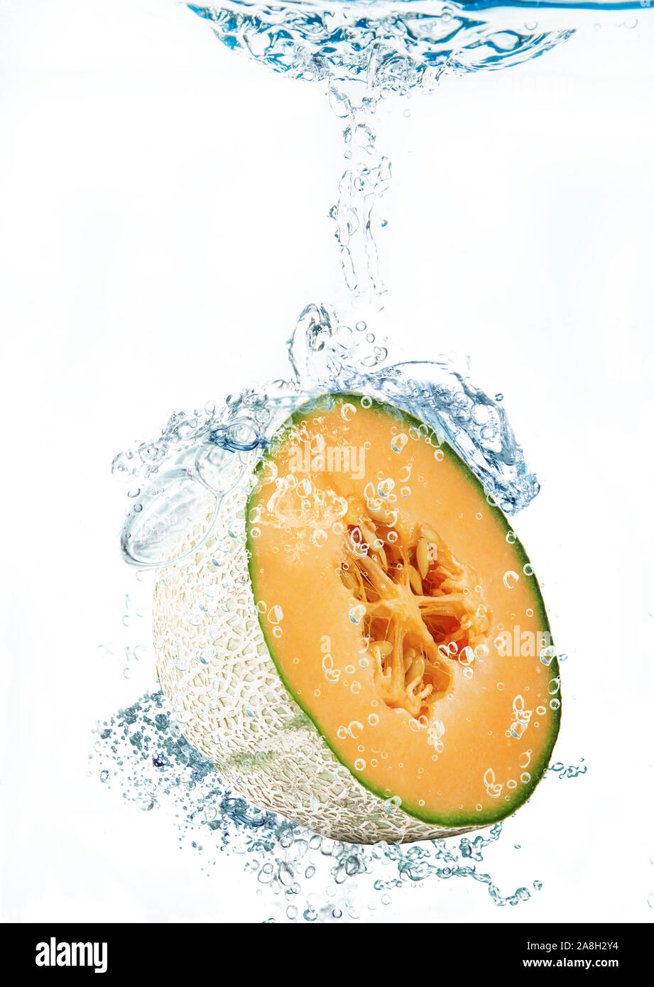 fresh melon falling in water Stock Photo - Alamy