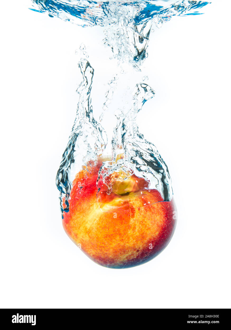 fresh peach falling in water Stock Photo - Alamy