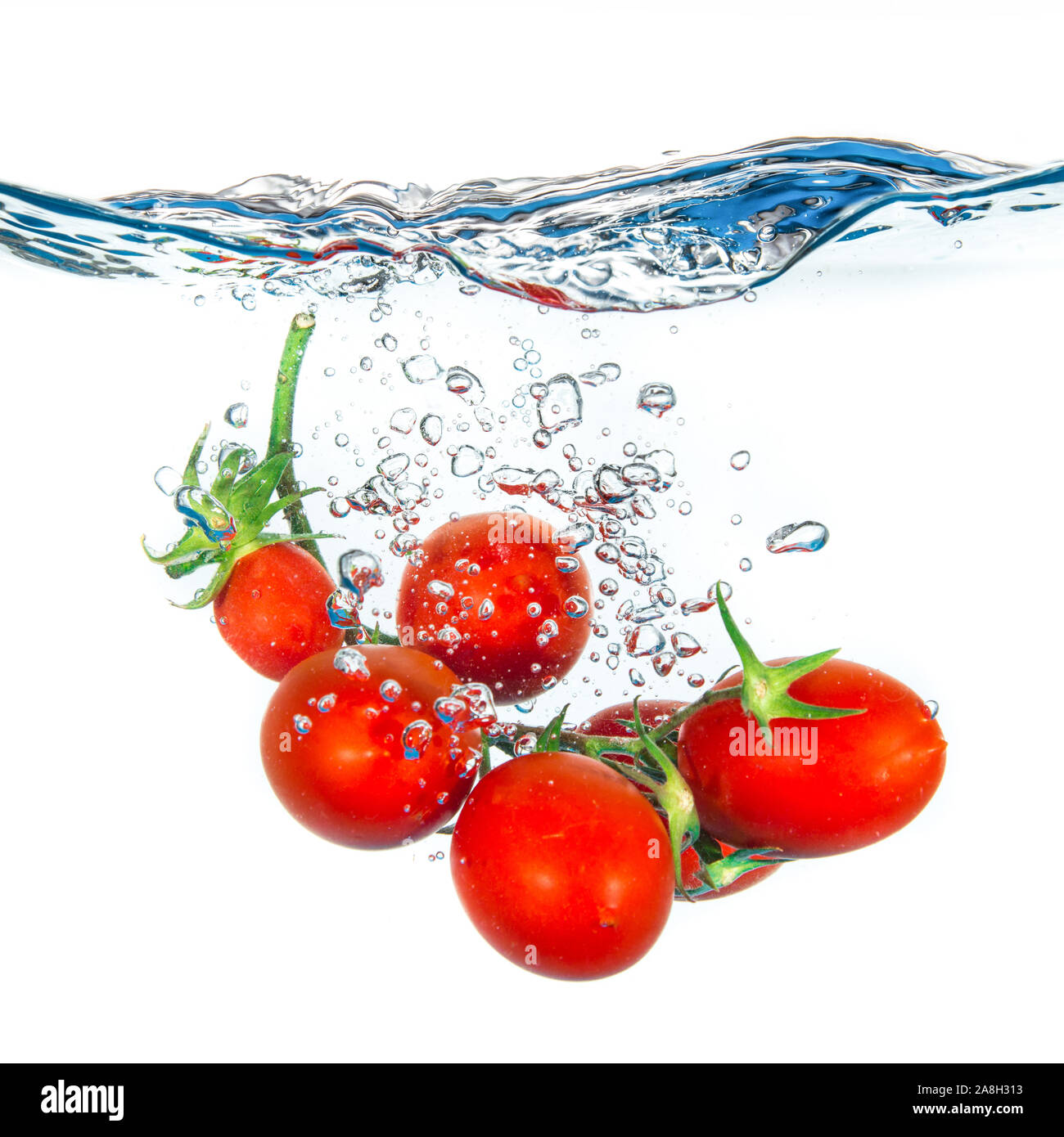 fresh tomatoes falling in pure water Stock Photo - Alamy