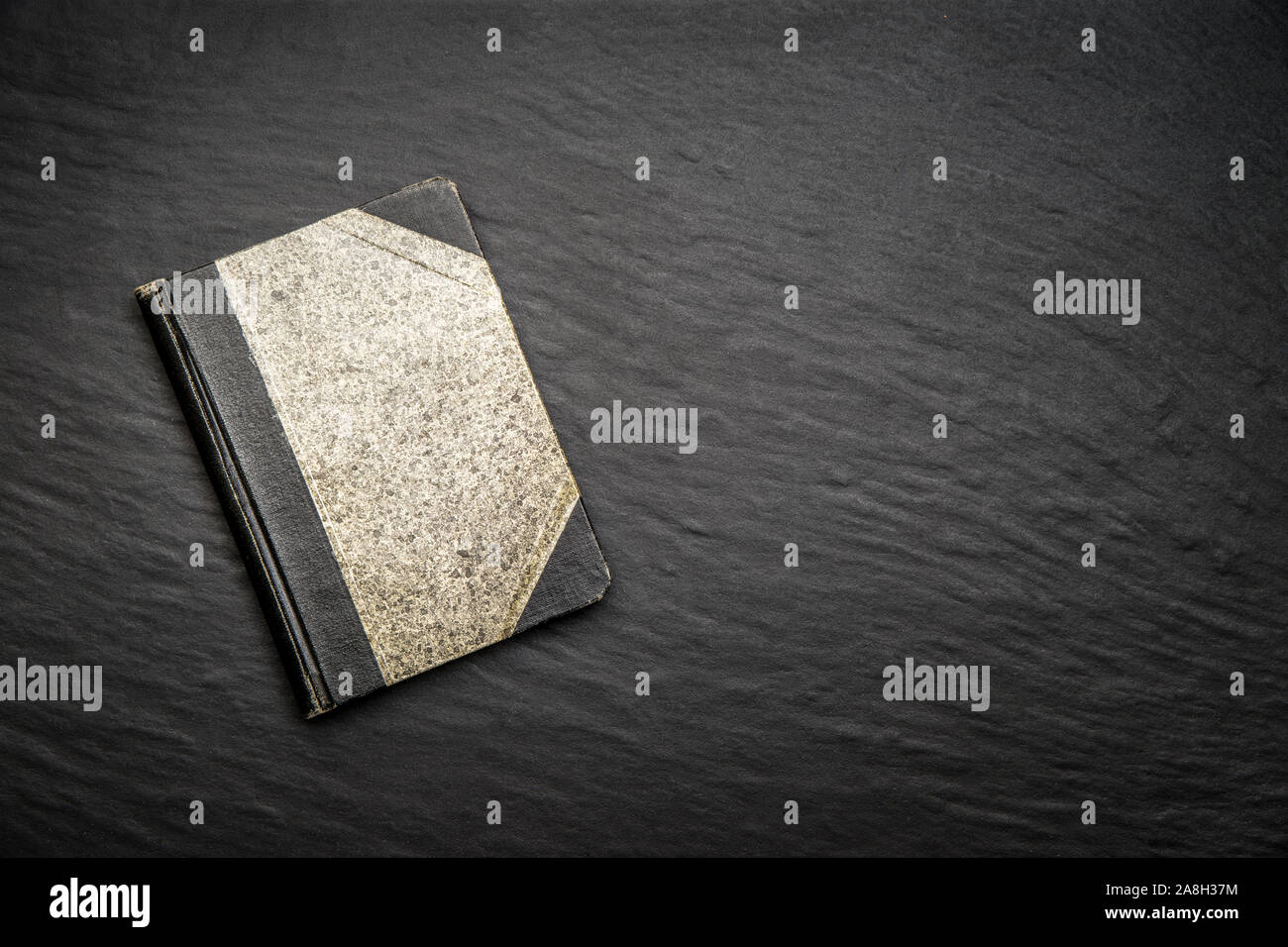 an Old diary on black stone background Stock Photo - Alamy