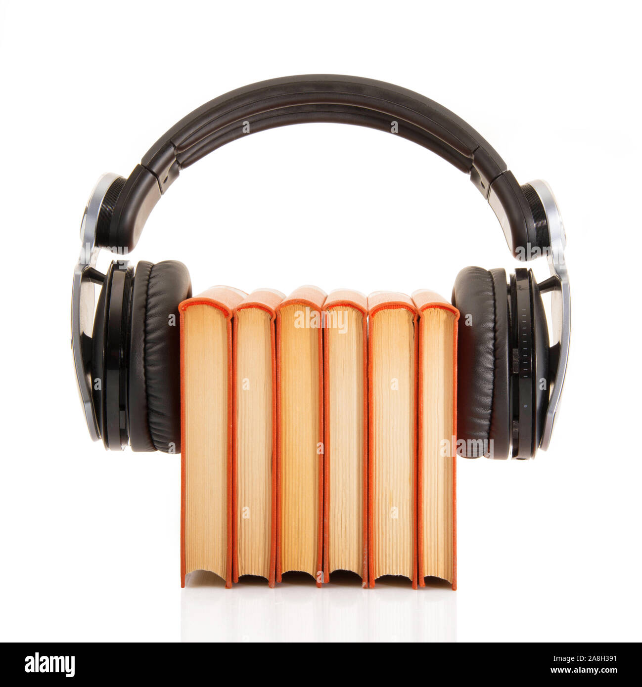 Books with headphones on white background Stock Photo - Alamy